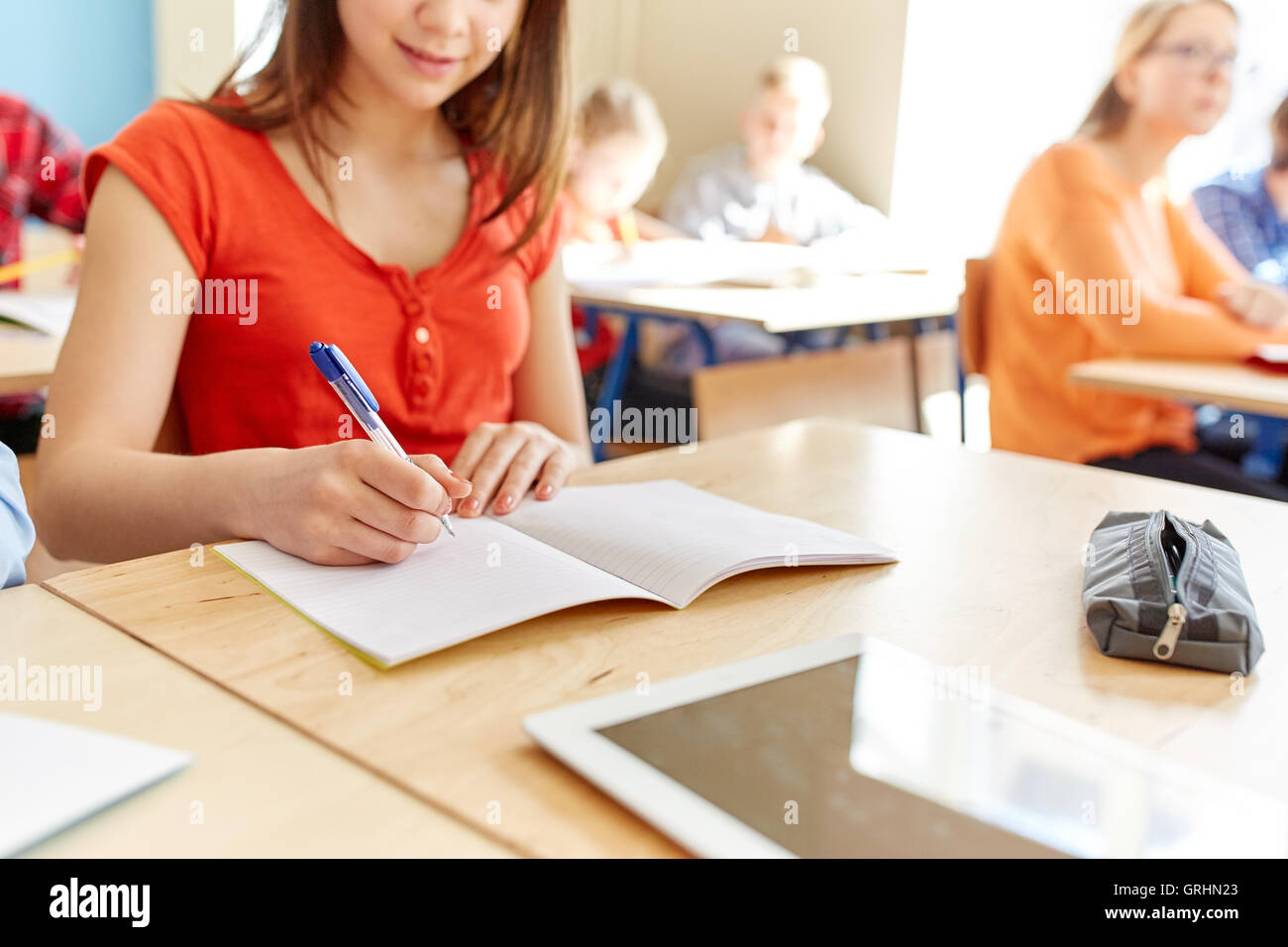 close up of student writing to notebook at school Stock Photo - Alamy