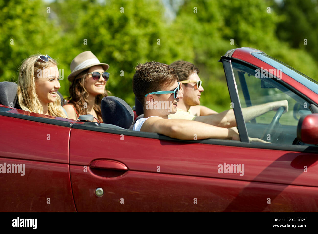 happy friends driving in cabriolet car Stock Photo - Alamy