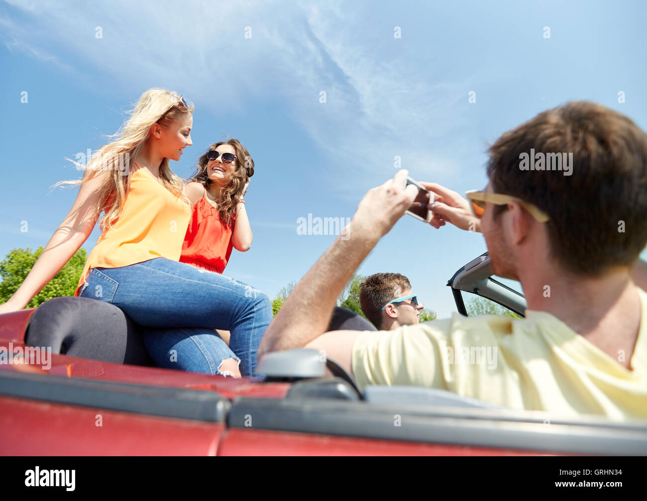 friends driving in car and photographing Stock Photo - Alamy