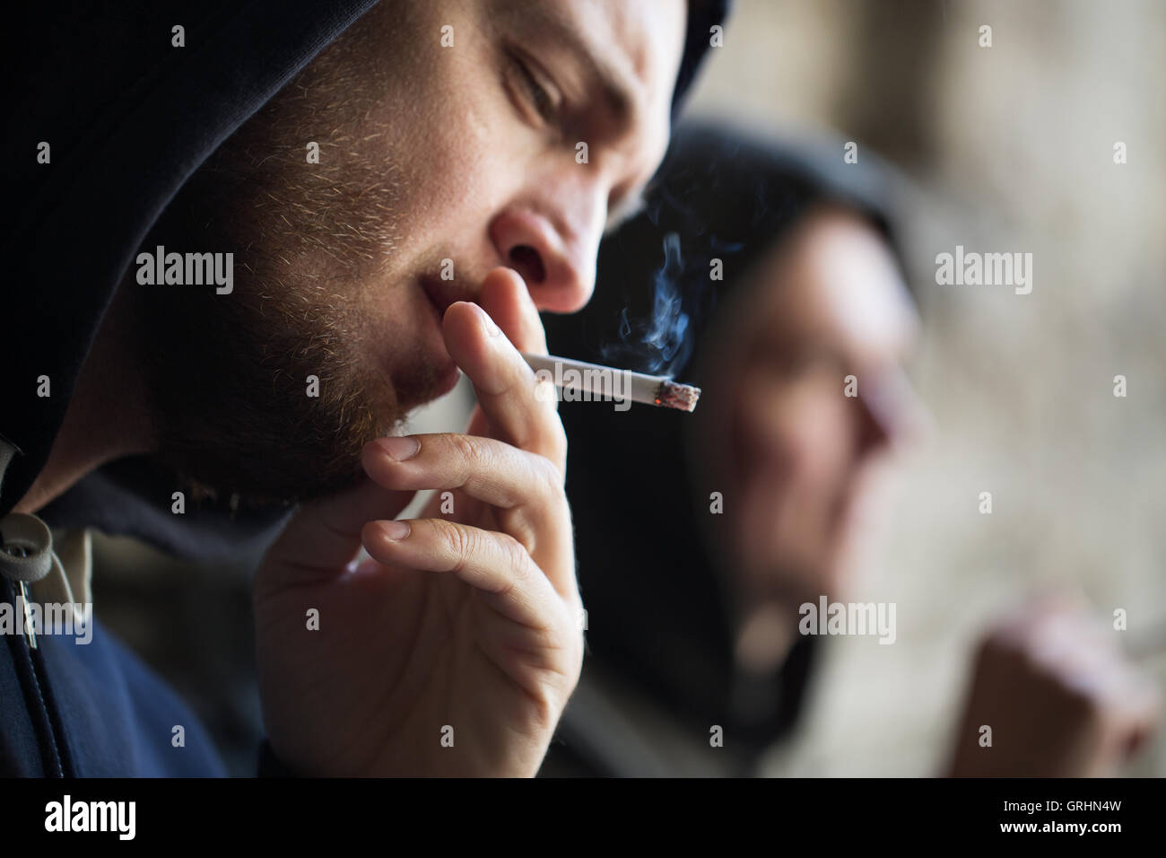 close up of young man smoking cigarette outdoors Stock Photo - Alamy