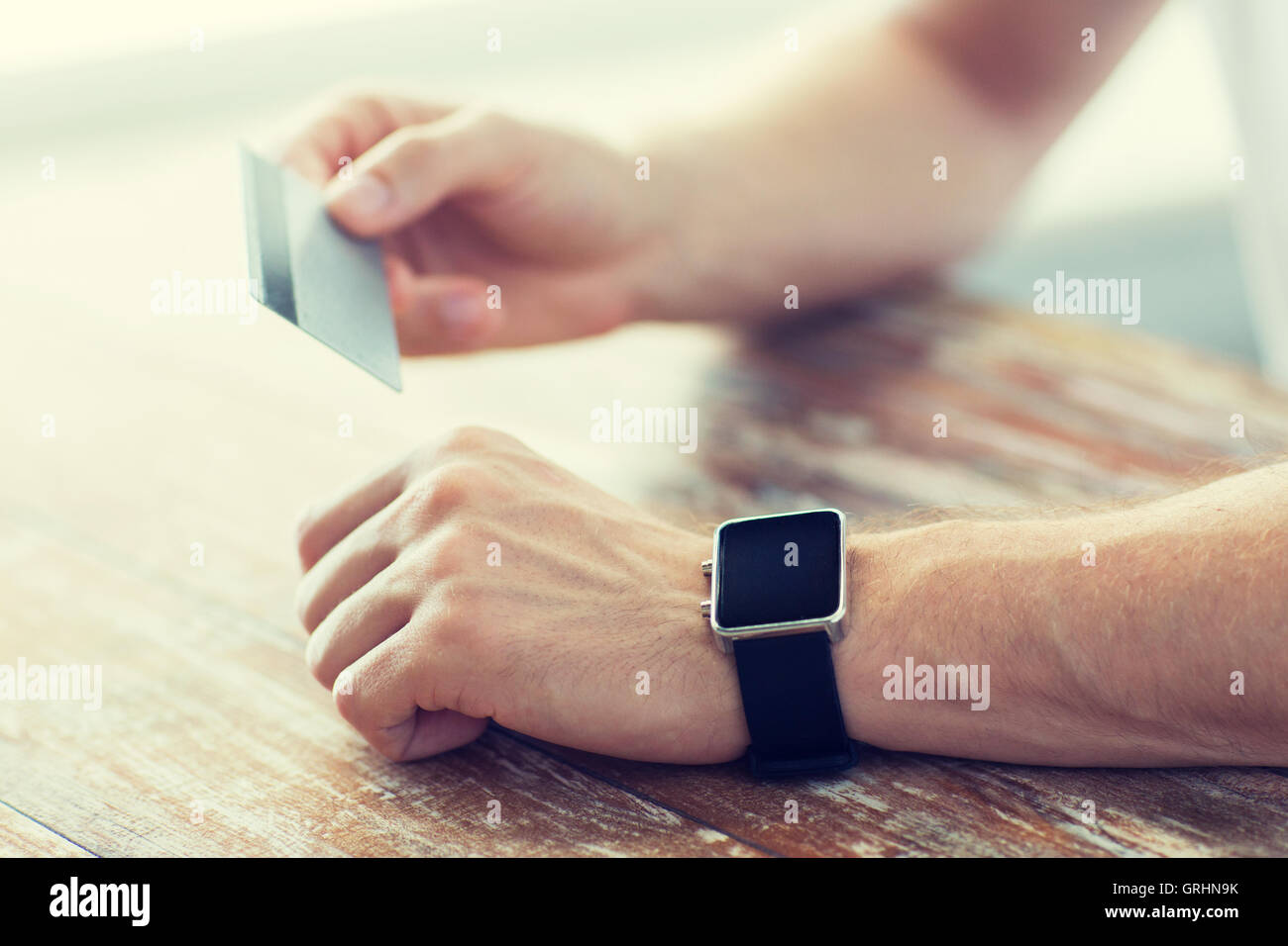 close up of hands with smart watch and credit card Stock Photo - Alamy