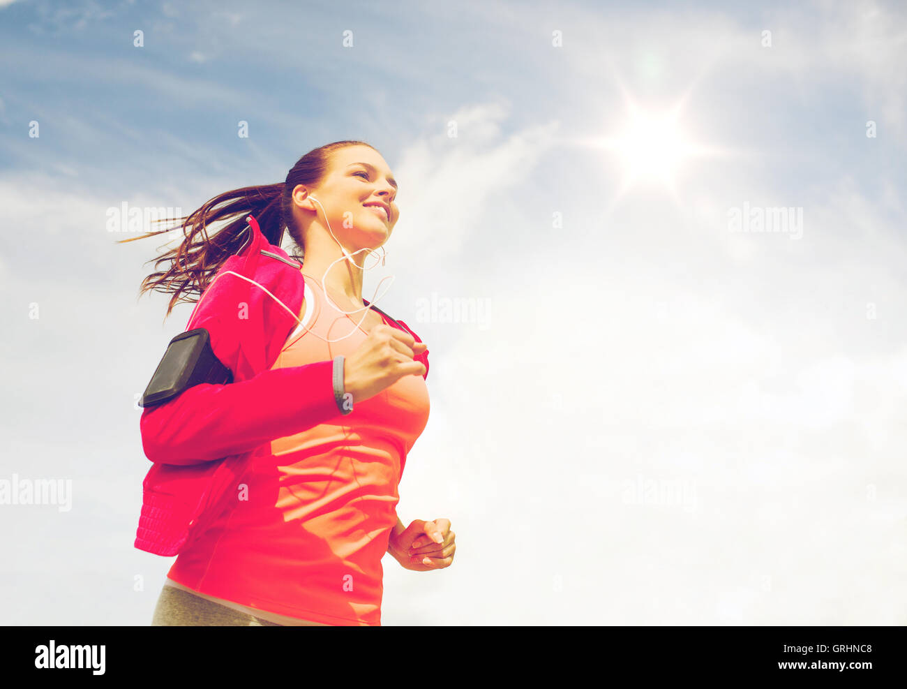 Running young woman smartphone hi-res stock photography and images - Alamy
