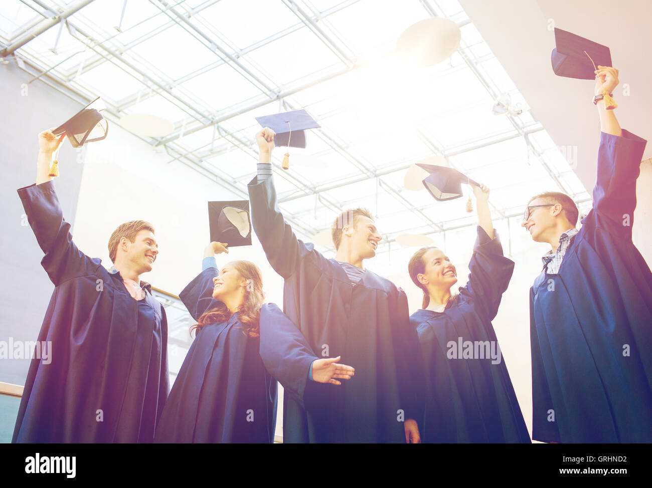 group of happy students in mortarboards at school Stock Photo - Alamy