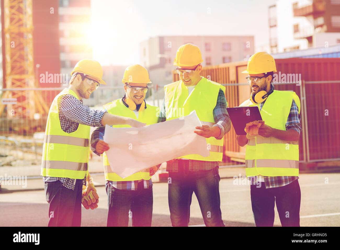 group of builders with blueprint and clipboard Stock Photo - Alamy