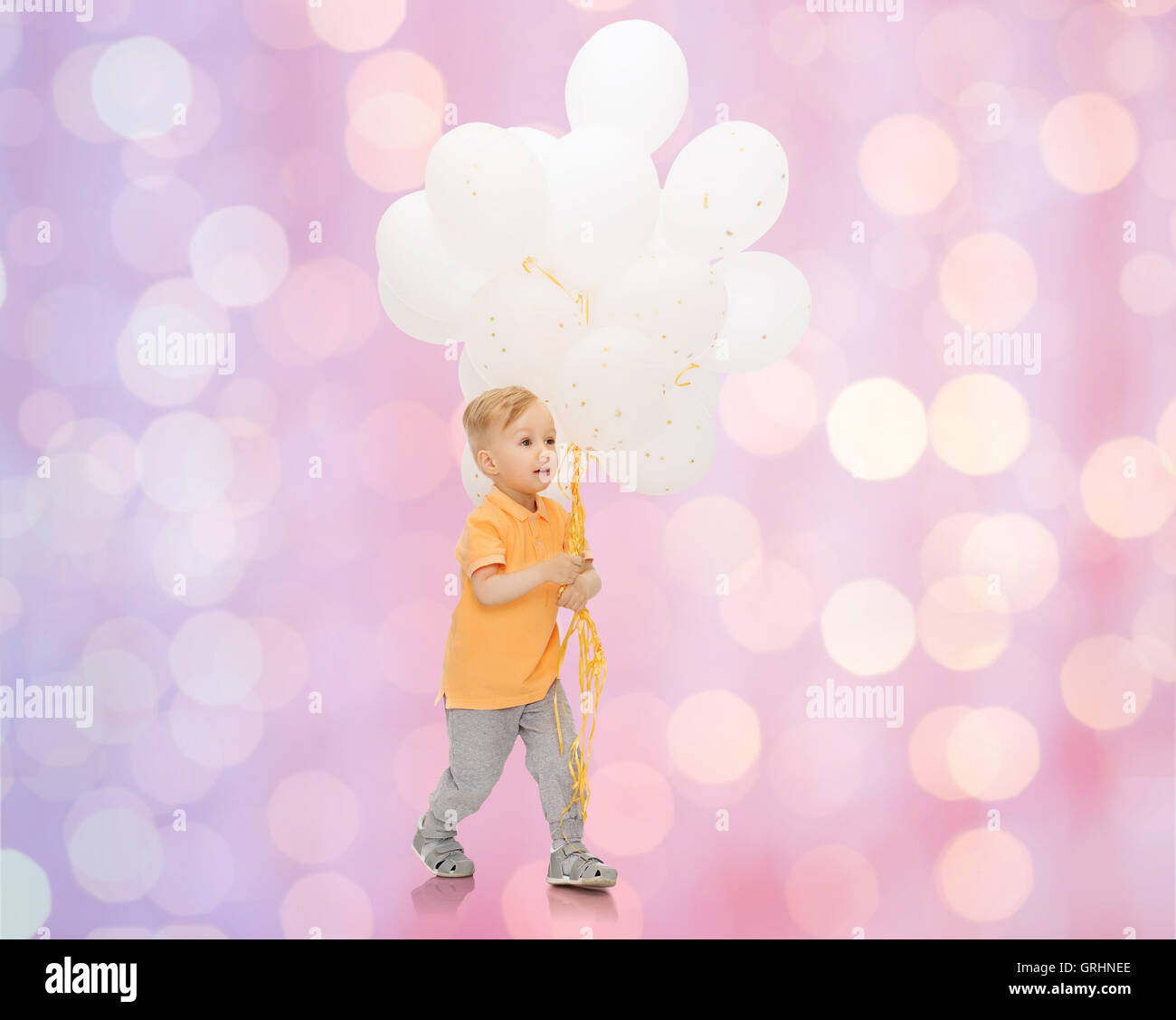 happy little baby boy with bunch of balloons Stock Photo - Alamy