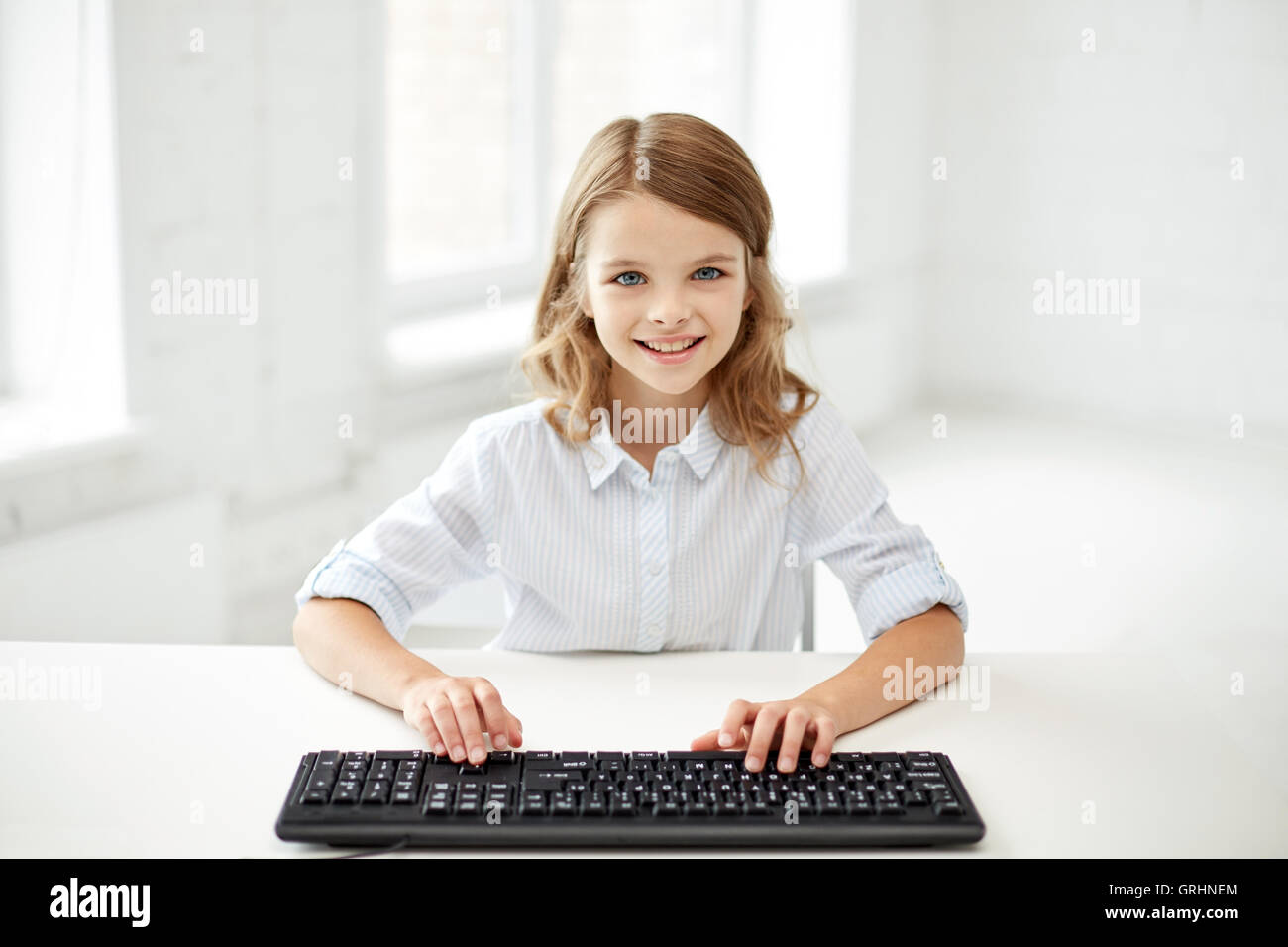 smiling girl with keyboard at school Stock Photo - Alamy