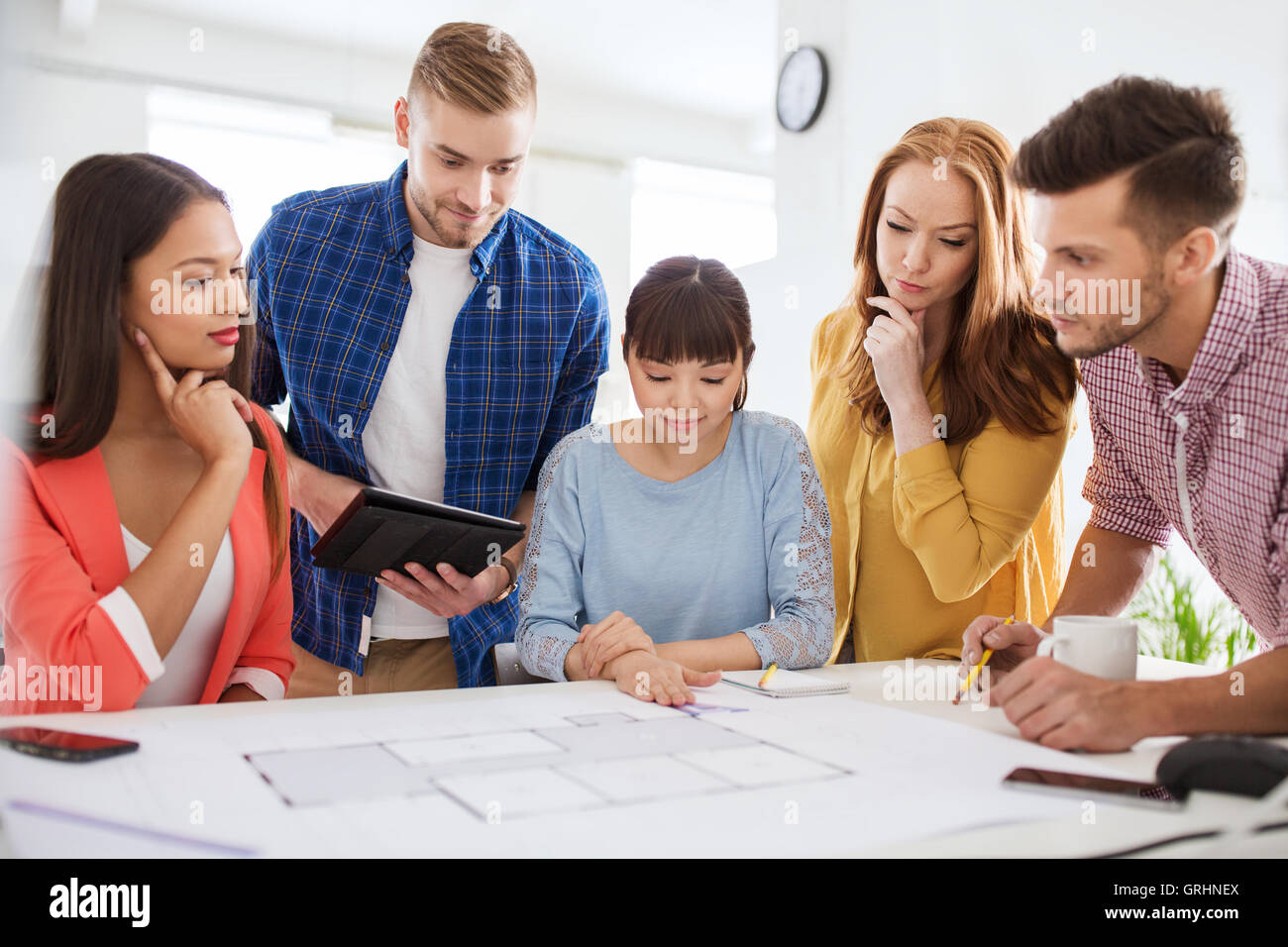 creative team with blueprint working at office Stock Photo - Alamy