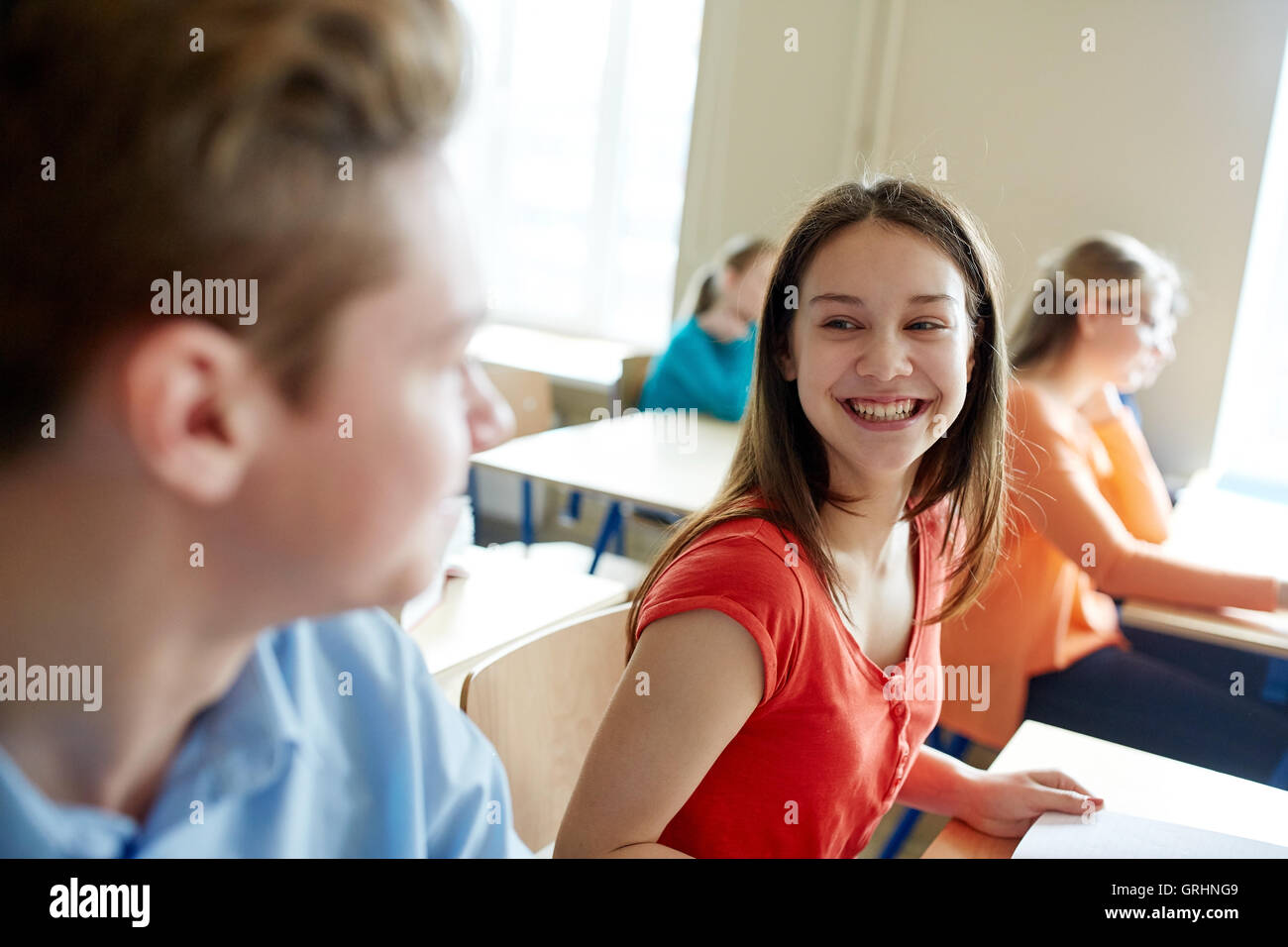 group of happy students talking at school break Stock Photo - Alamy