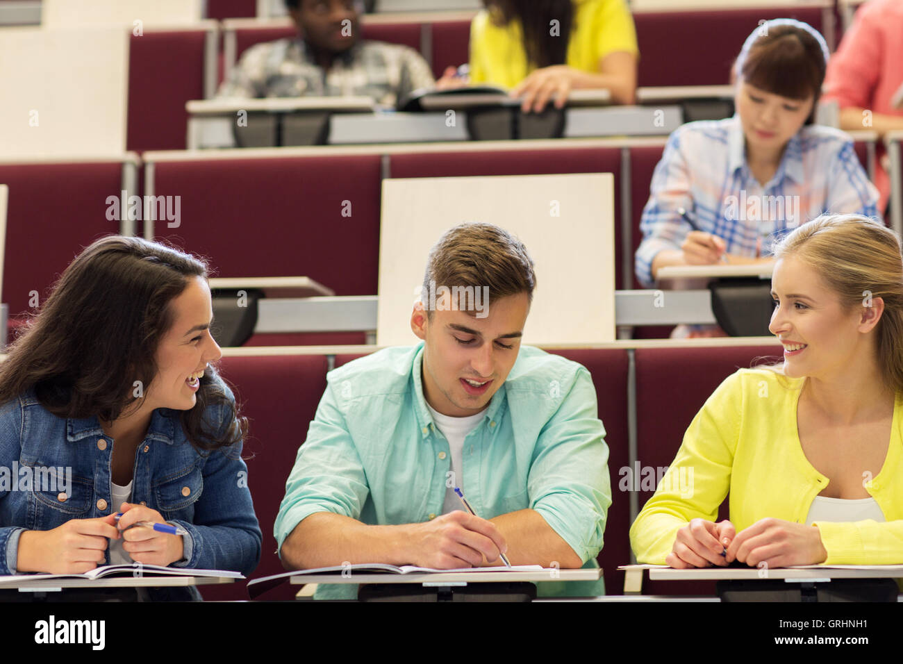 group of students with notebooks in lecture hall Stock Photo - Alamy