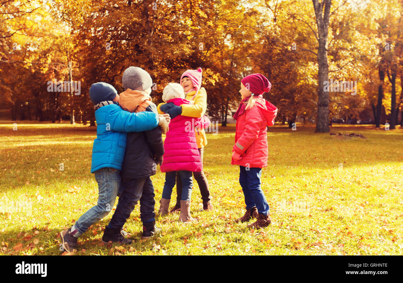 group of happy children hugging in autumn park Stock Photo - Alamy