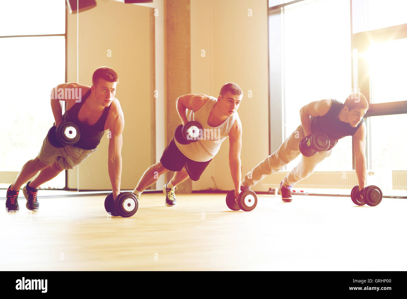 group of men with dumbbells in gym Stock Photo - Alamy