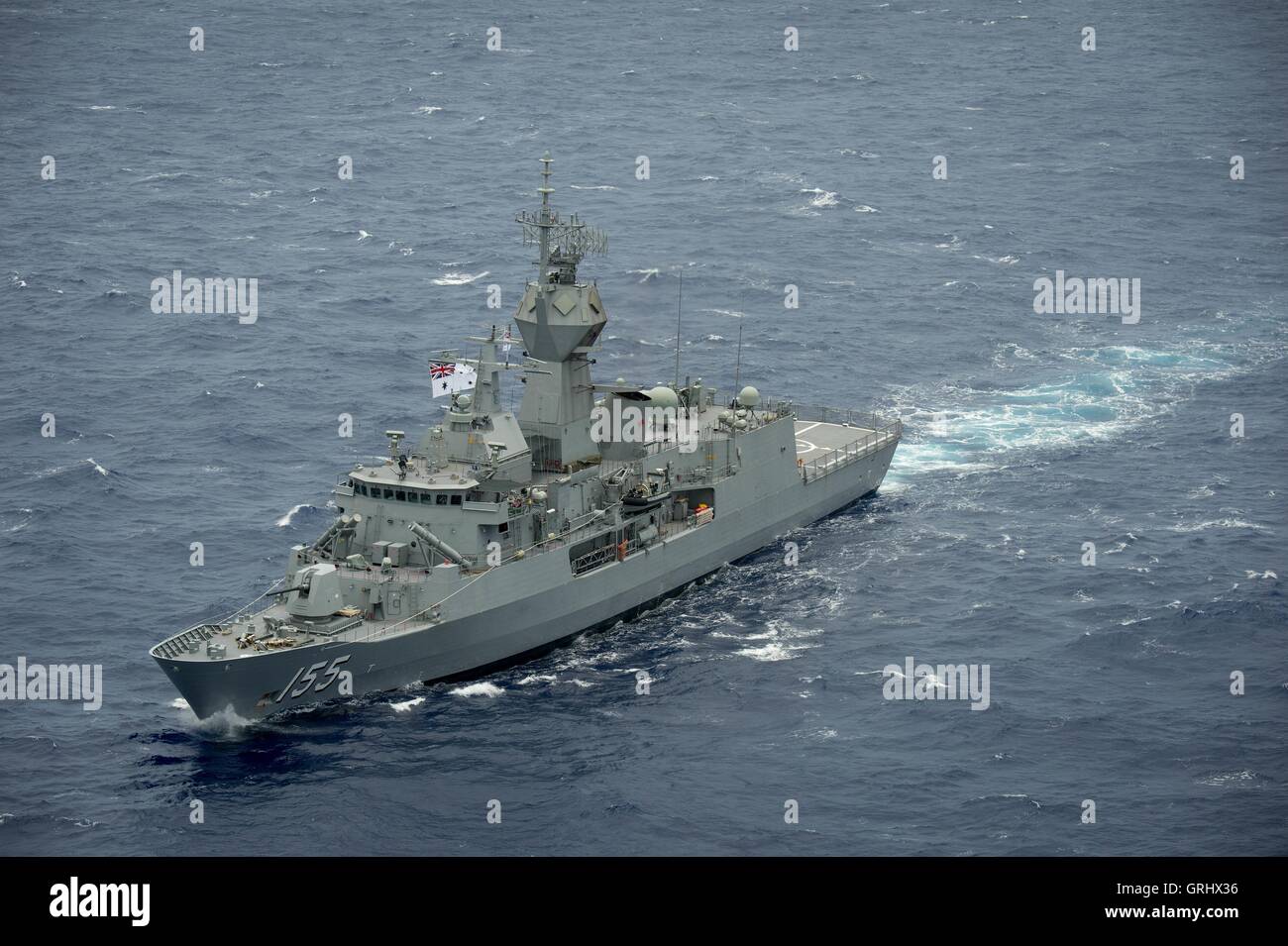 Royal Australian Navy Anzac Class frigate HMAS Ballarat steams in close ...