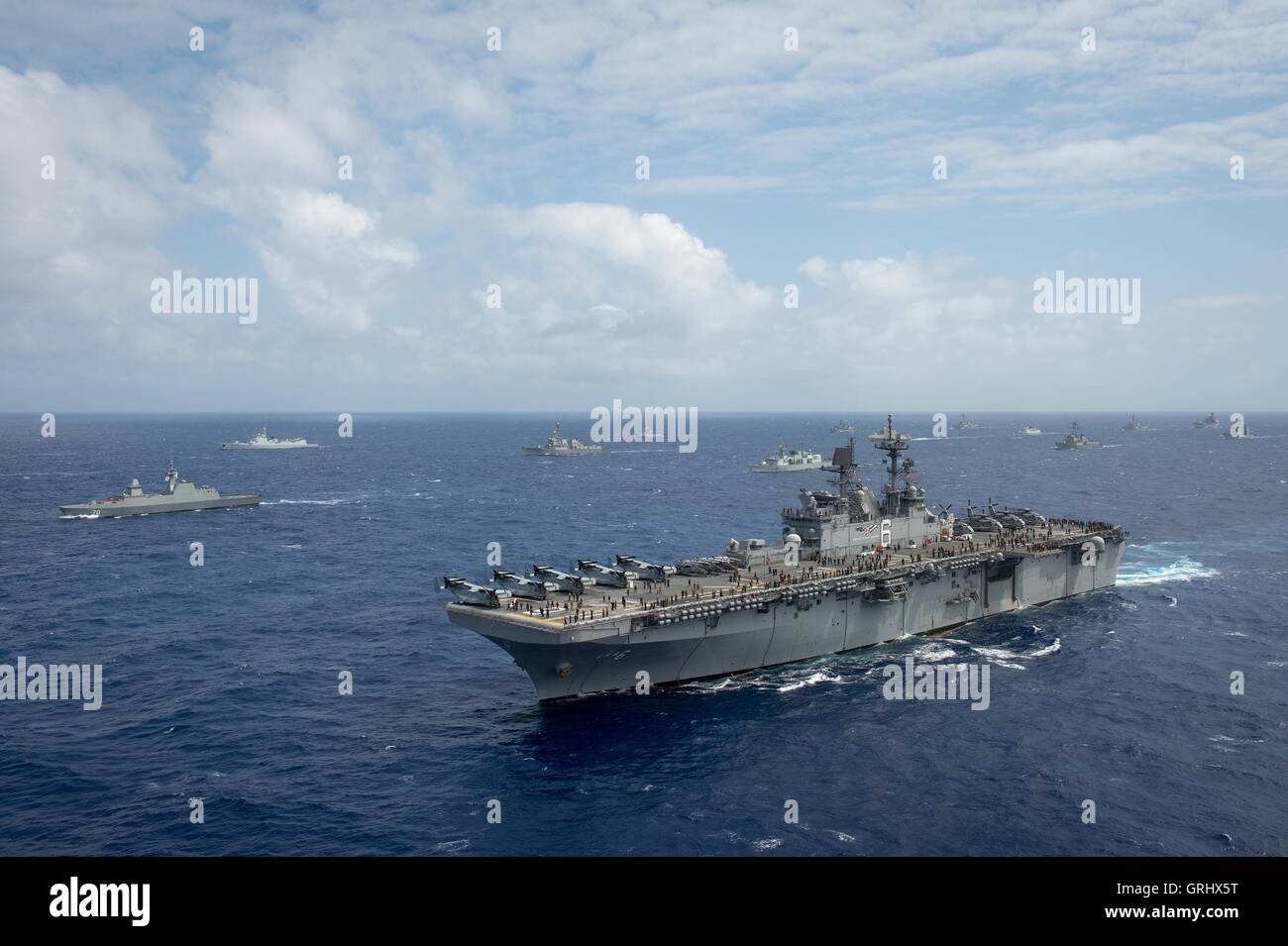 U.S. Navy Amphibious assault ship USS America steams in close formation ...