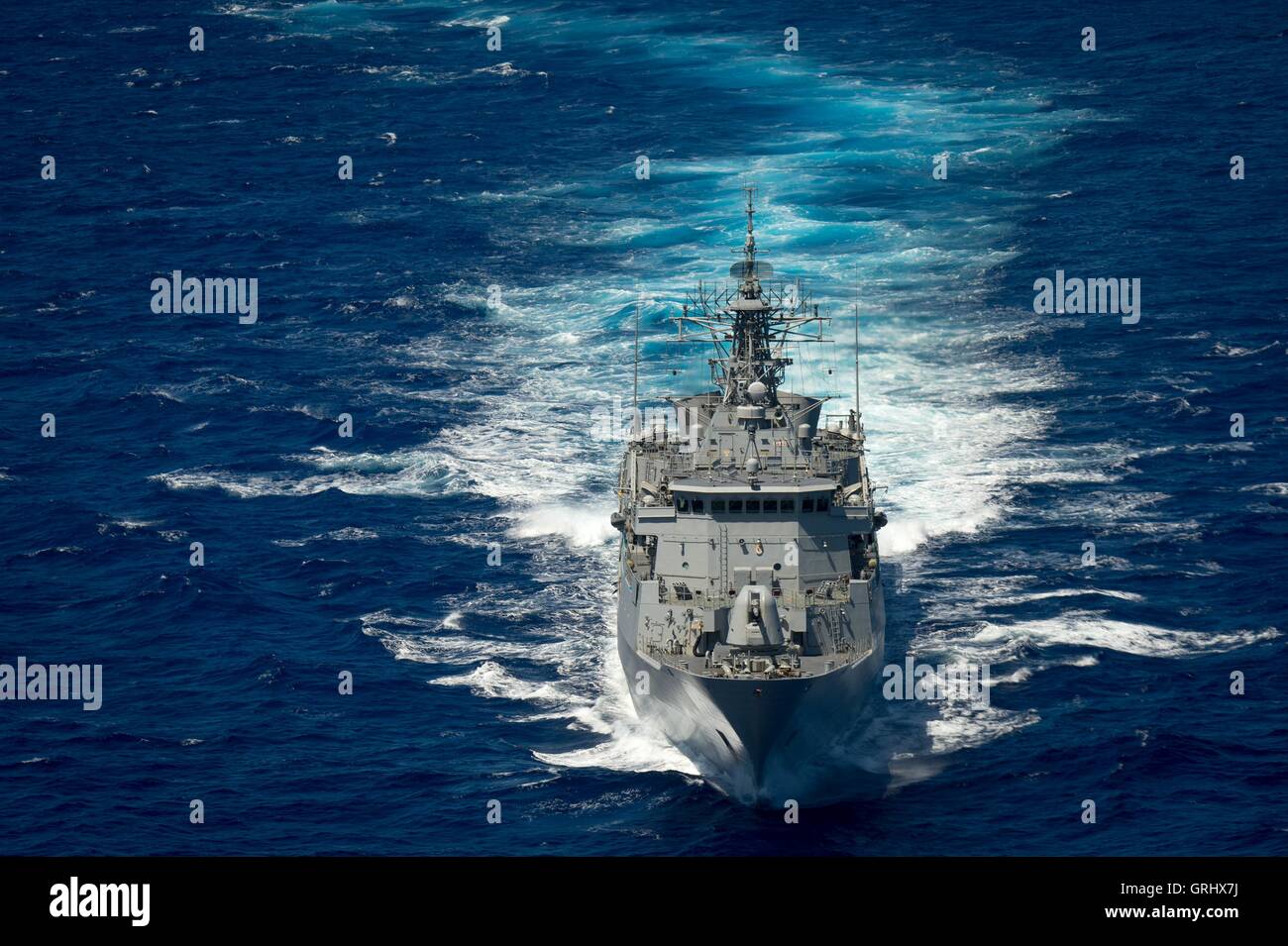 Royal New Zealand Navy ship HMNZS Te Kaha steams in close formation ...
