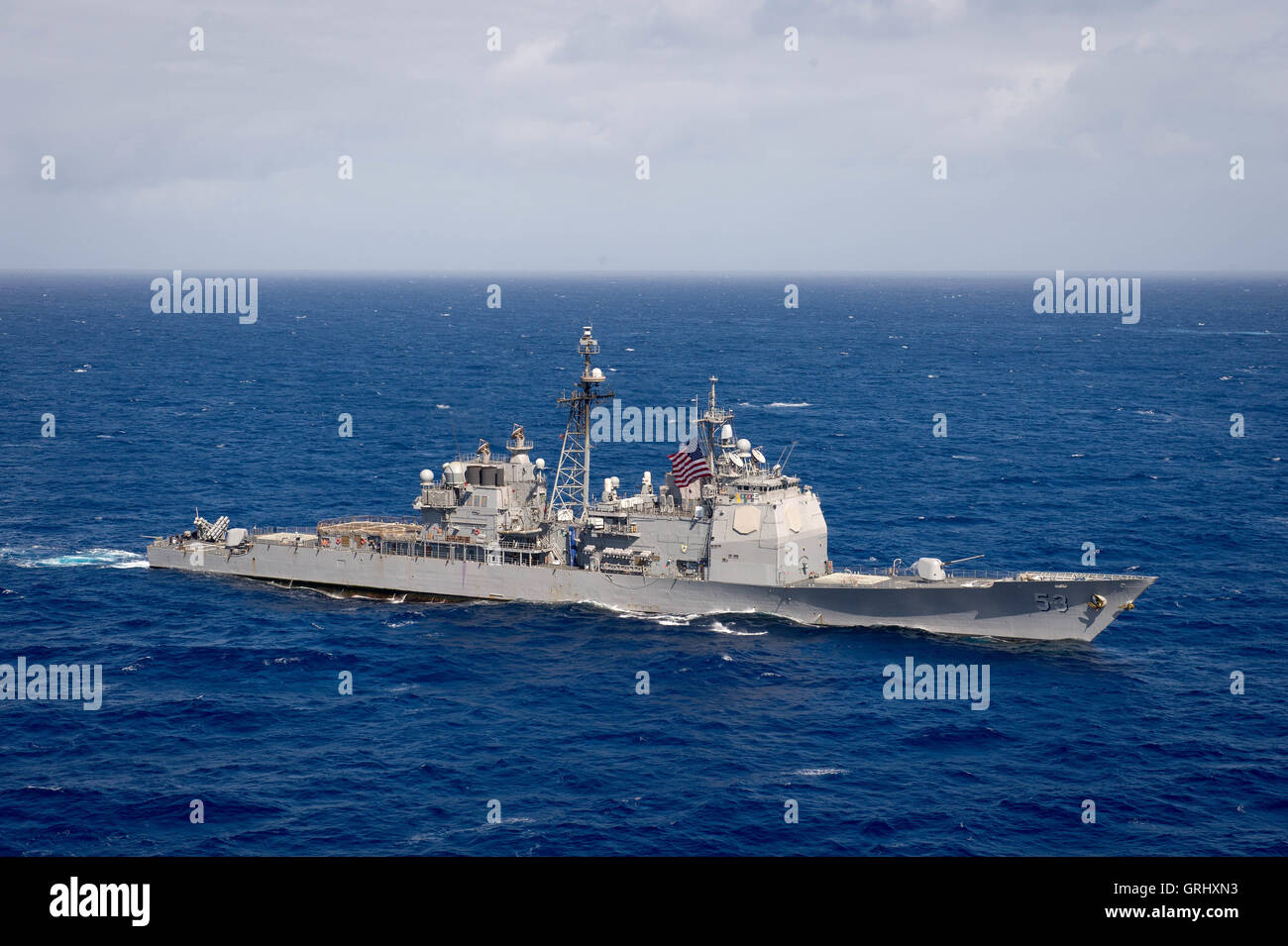 U.S. Navy Guided-missile cruiser USS Mobile Bay steams in close ...