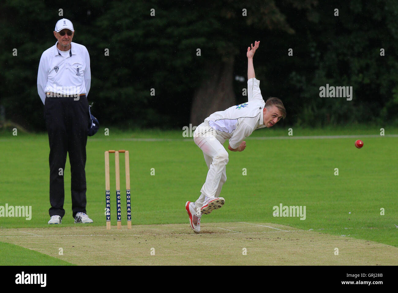 G Ellis in bowling action for Woodford Wells during Woodford Wells CC ...