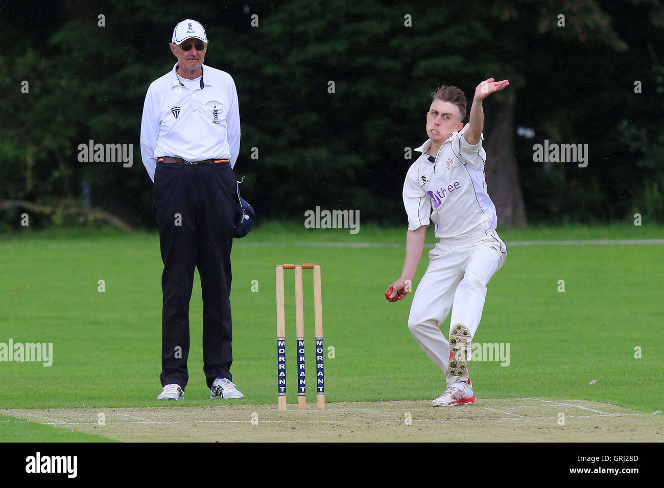 G Ellis in bowling action for Woodford Wells during Woodford Wells CC ...