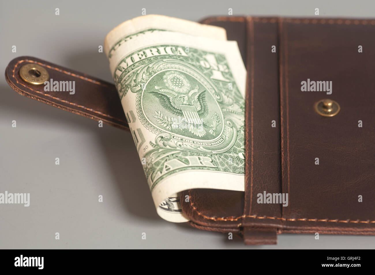 Brown Leather Wallet With One Dollars On Gray Background Stock Photo ...