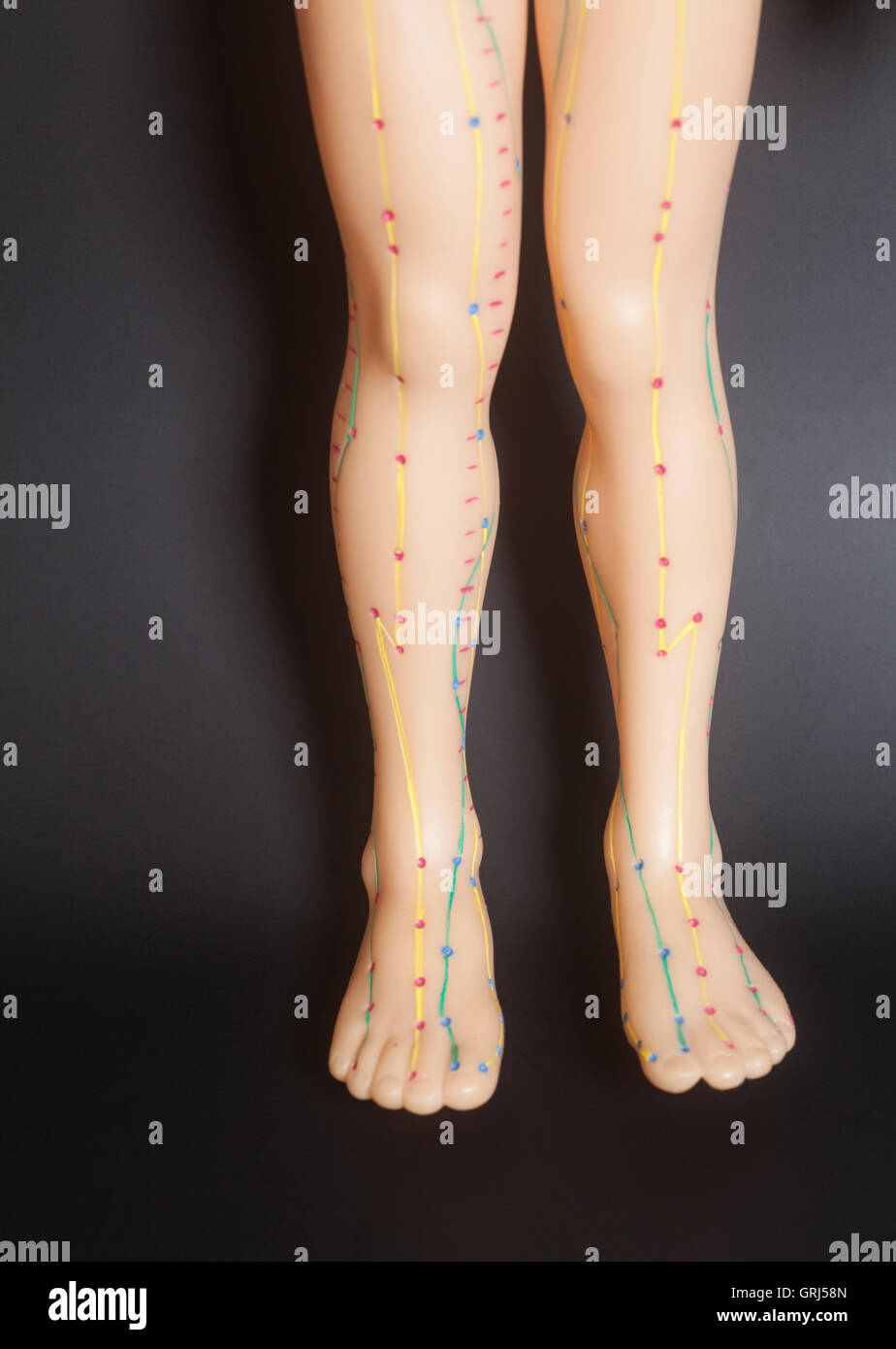 Medical acupuncture model of human feet on black background Stock Photo ...