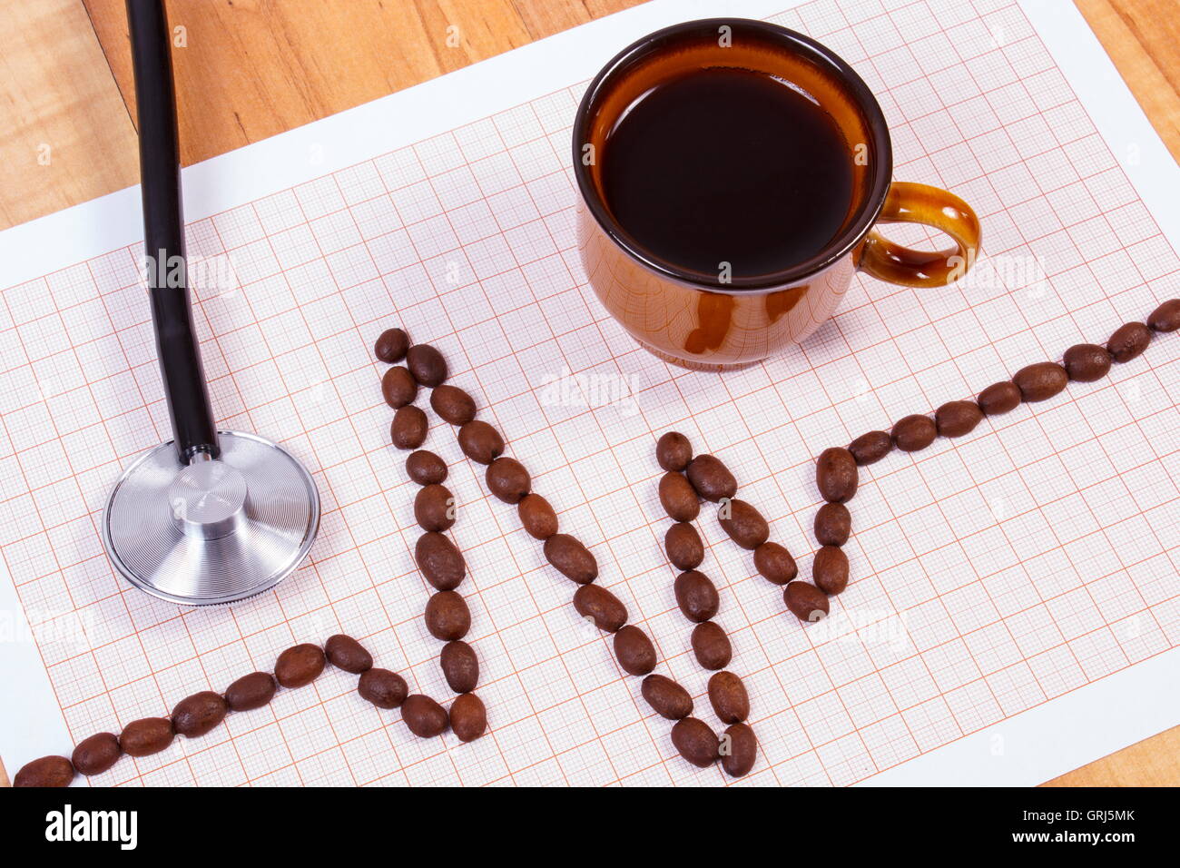 Electrocardiogram line of roasted coffee grains, cup of hot coffee and ...