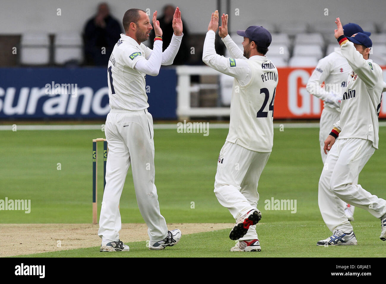 Charl Willoughby of Essex (L) claims the wicket of Ben Harmison and ...
