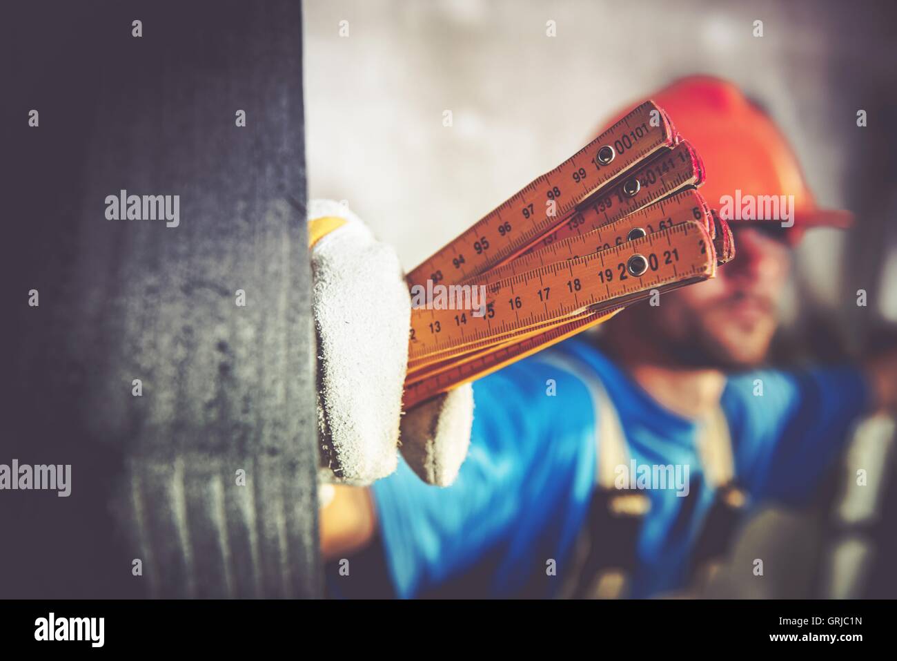 Construction Worker with Measuring Tool Closeup Photo. Home ...