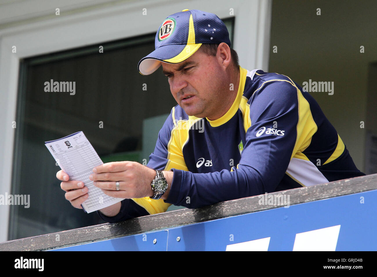 Australia coach Mickey Arthur reads the scorecard on the dressing room ...