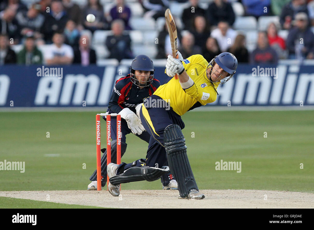 Jimmy Adams of Hampshire hits four runs as James Foster looks on ...