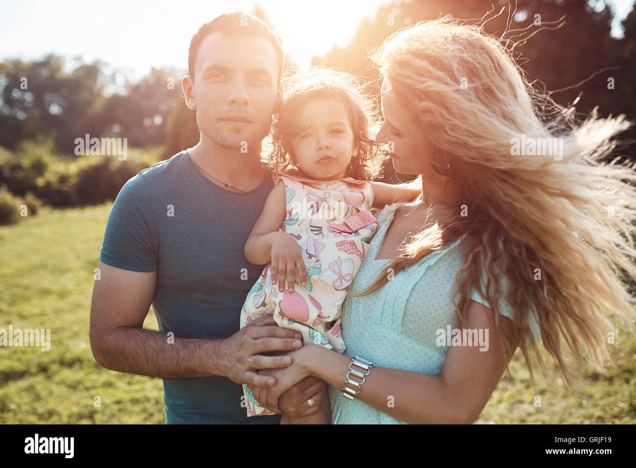 Beautiful happy family spending time together outside in green nature ...