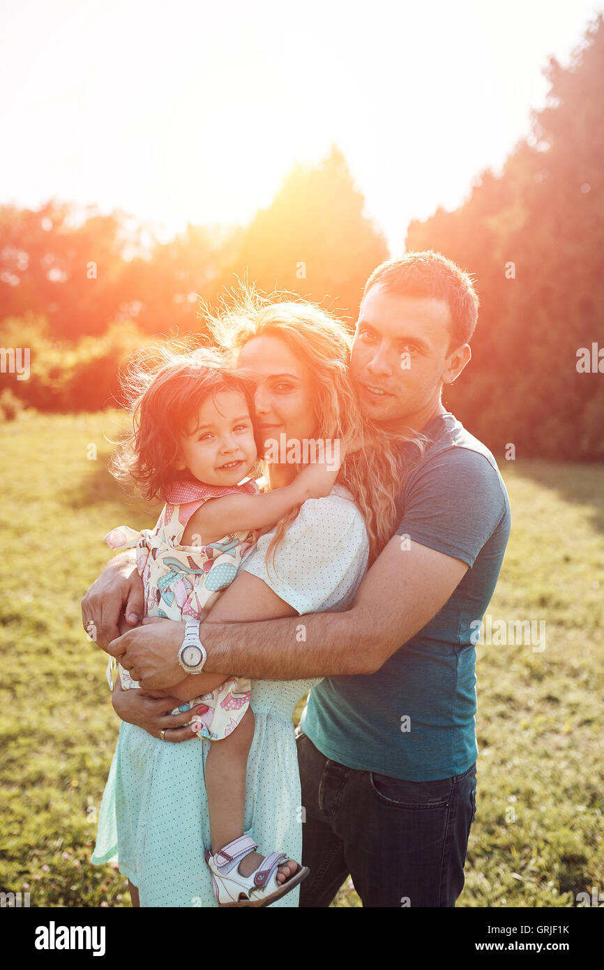 Beautiful happy family spending time together outside in green nature ...