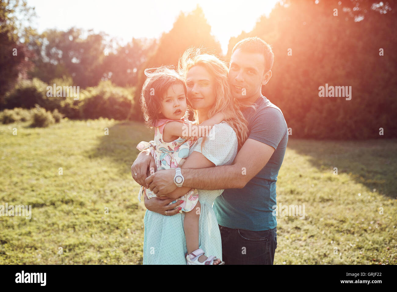 Beautiful happy family spending time together outside in green nature ...