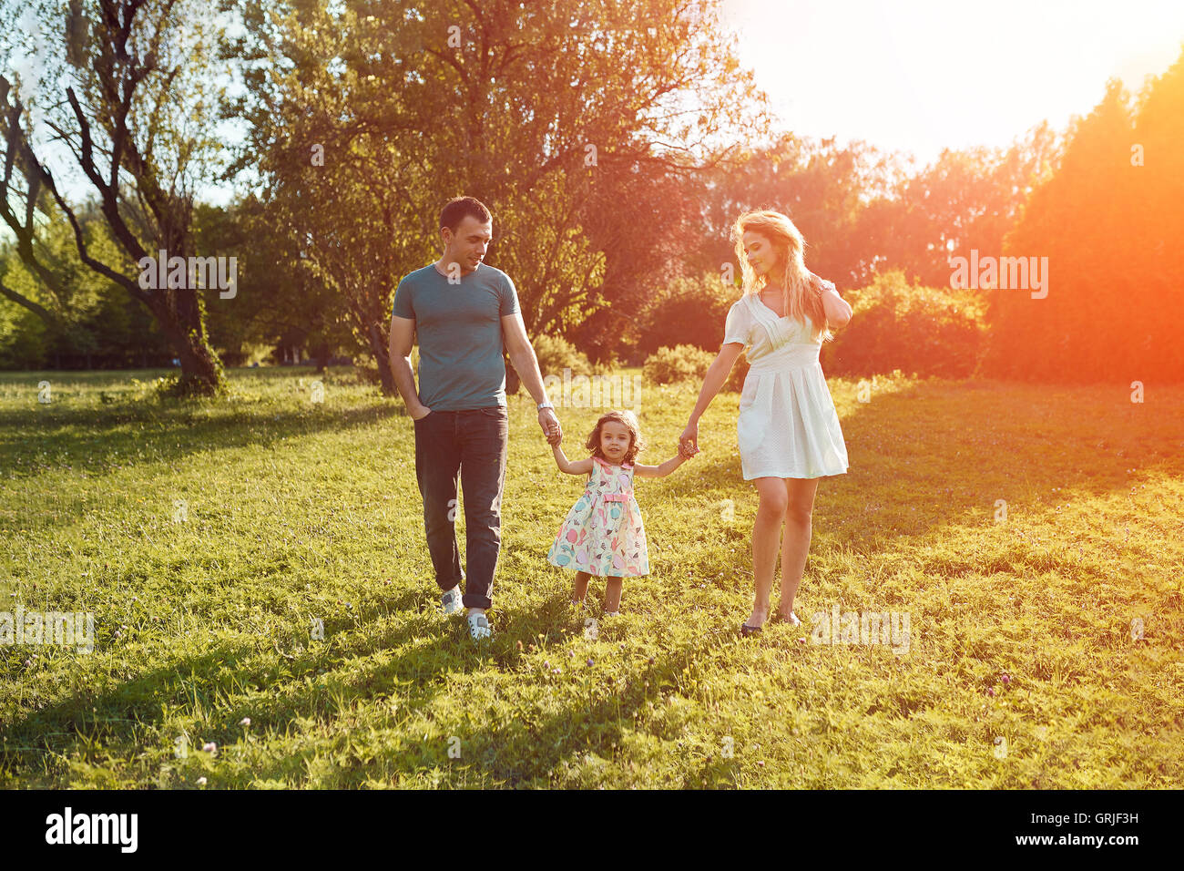 Beautiful happy family spending time together outside in green nature ...