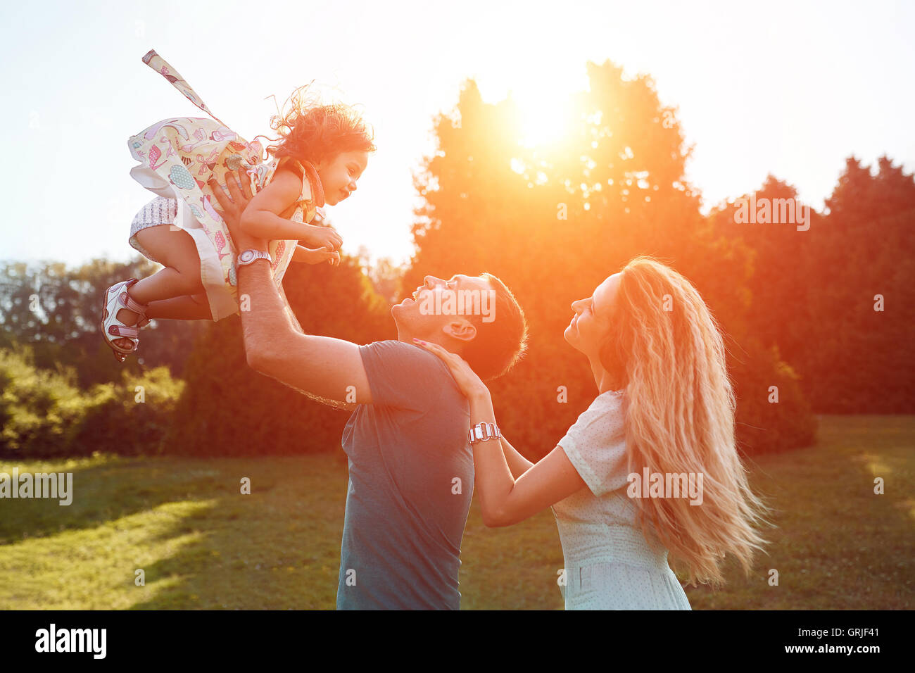 Beautiful happy family spending time together outside in green nature ...