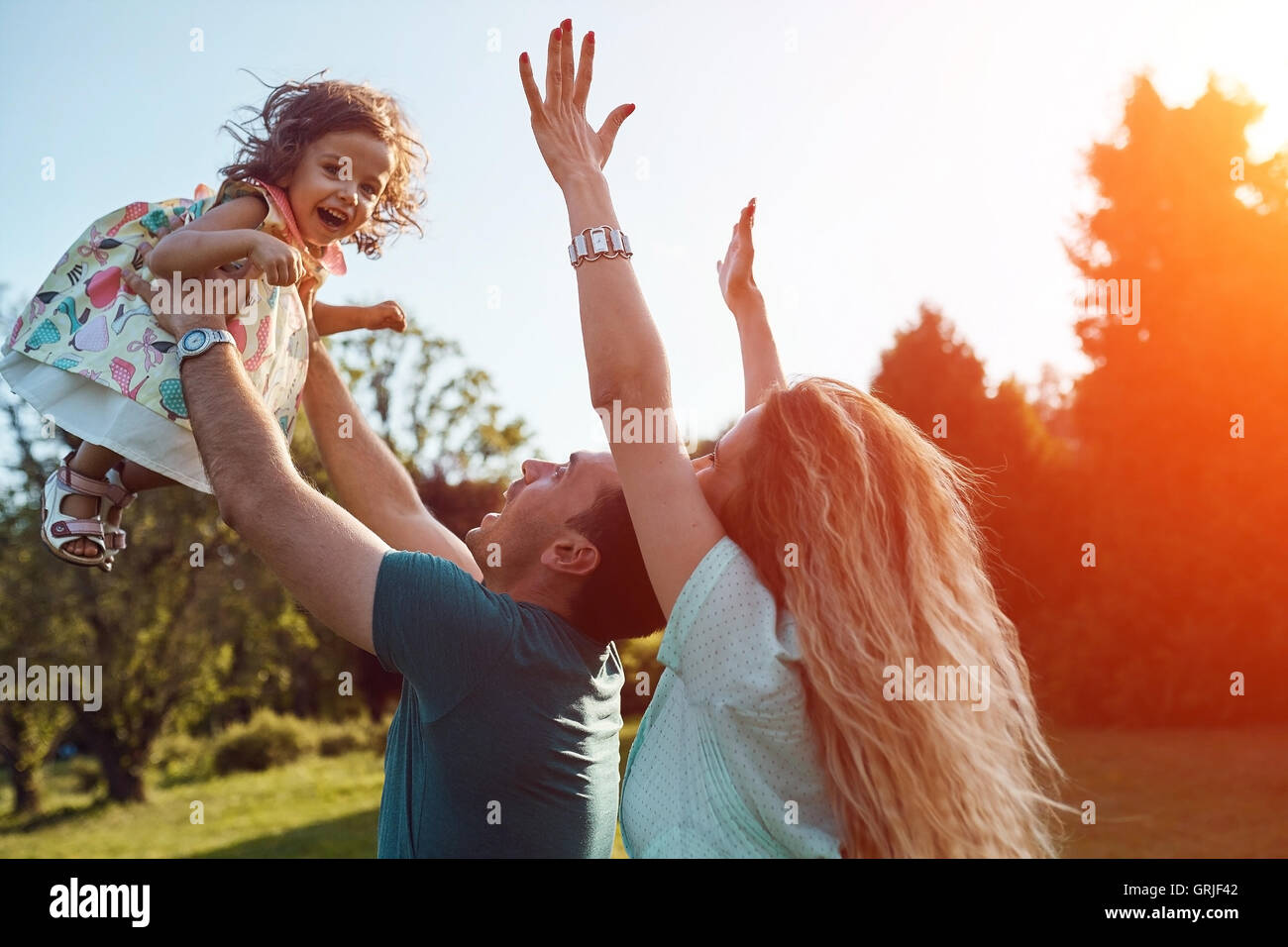 Beautiful happy family spending time together outside in green nature ...