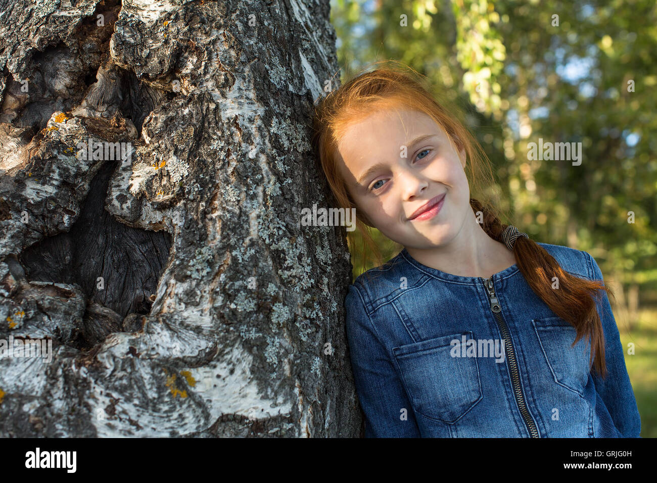 Portrait of a little girl near the tree Stock Photo - Alamy