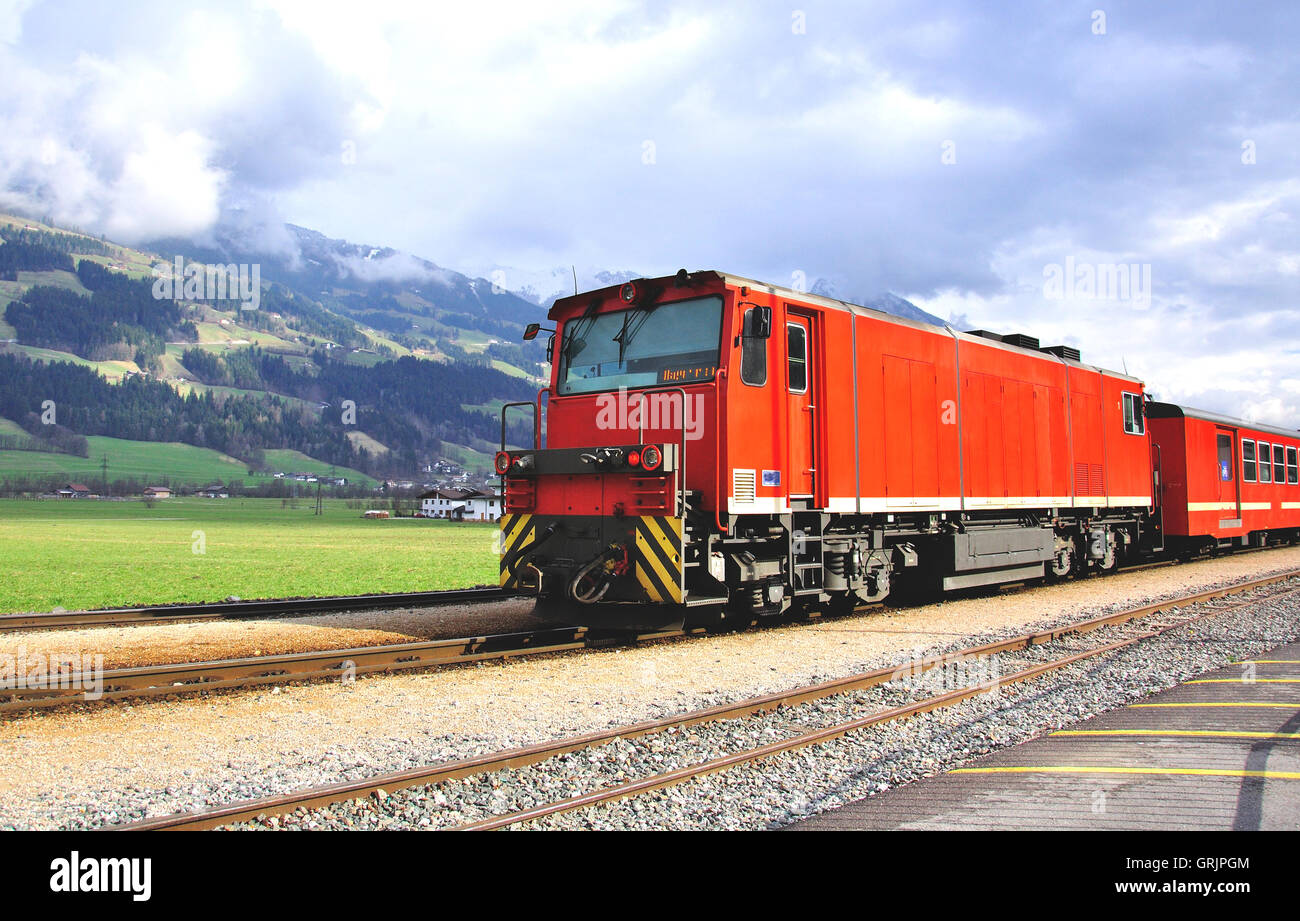 Old fashioned red train goes through the austrian Alps, Zillertal ...