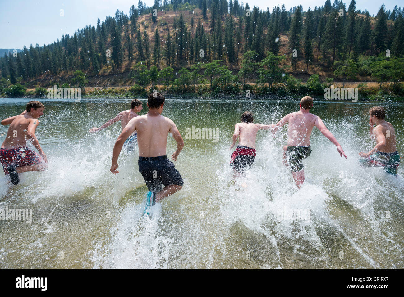 A group of Boy Scouts run into the Clearwater River to cool off on a ...