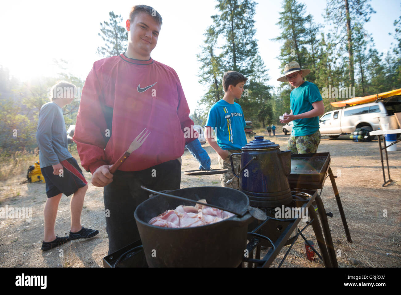 A Boy Scout prepares breakfast at basecamp in Orofino, Idaho Stock ...