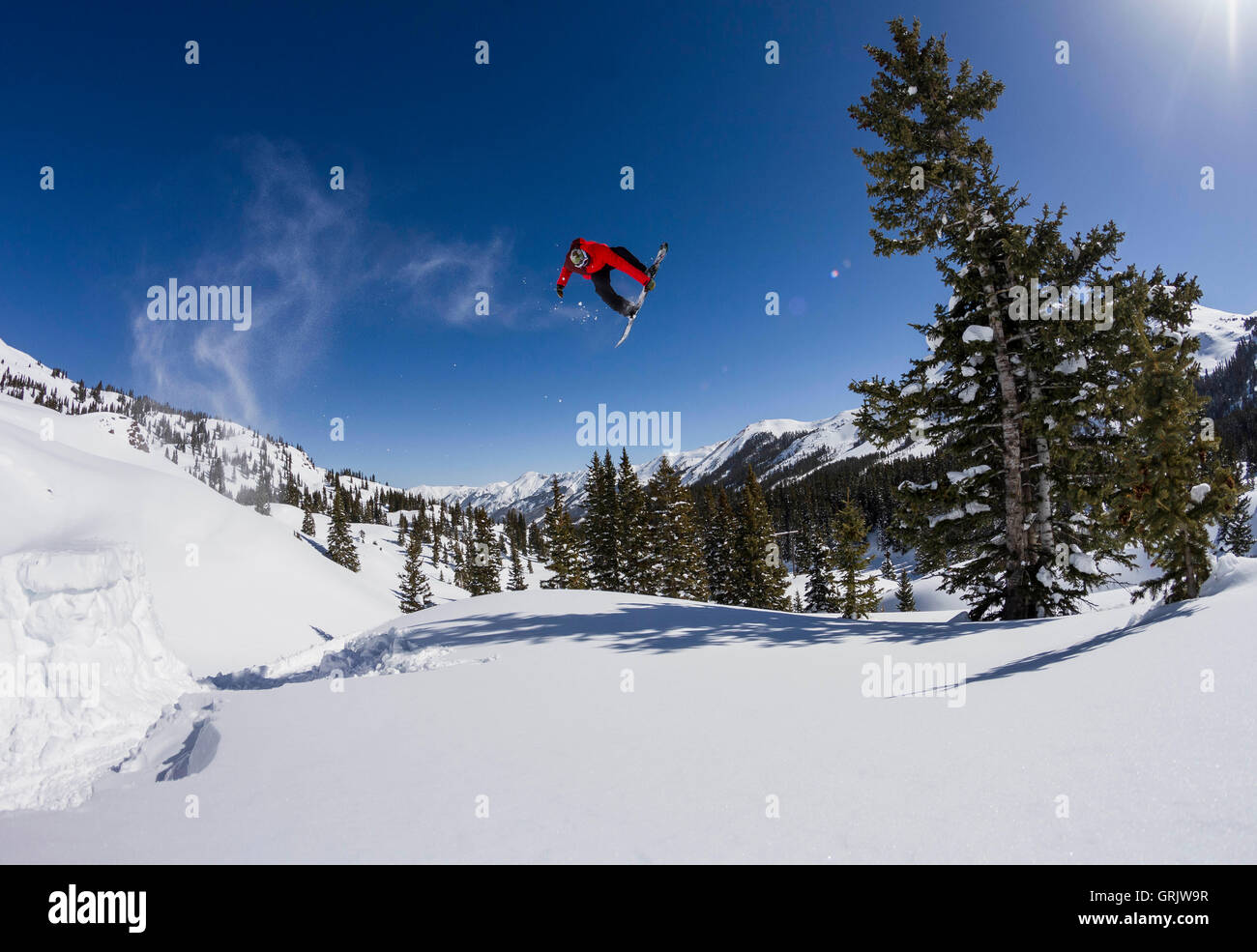 Snowboarder Hitting Jump Stock Photo - Alamy
