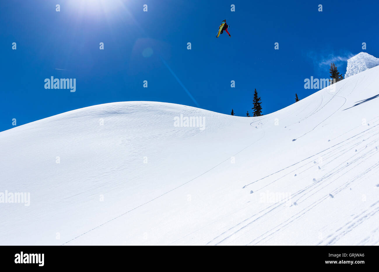 Snowboarder Hitting a Jump Stock Photo - Alamy