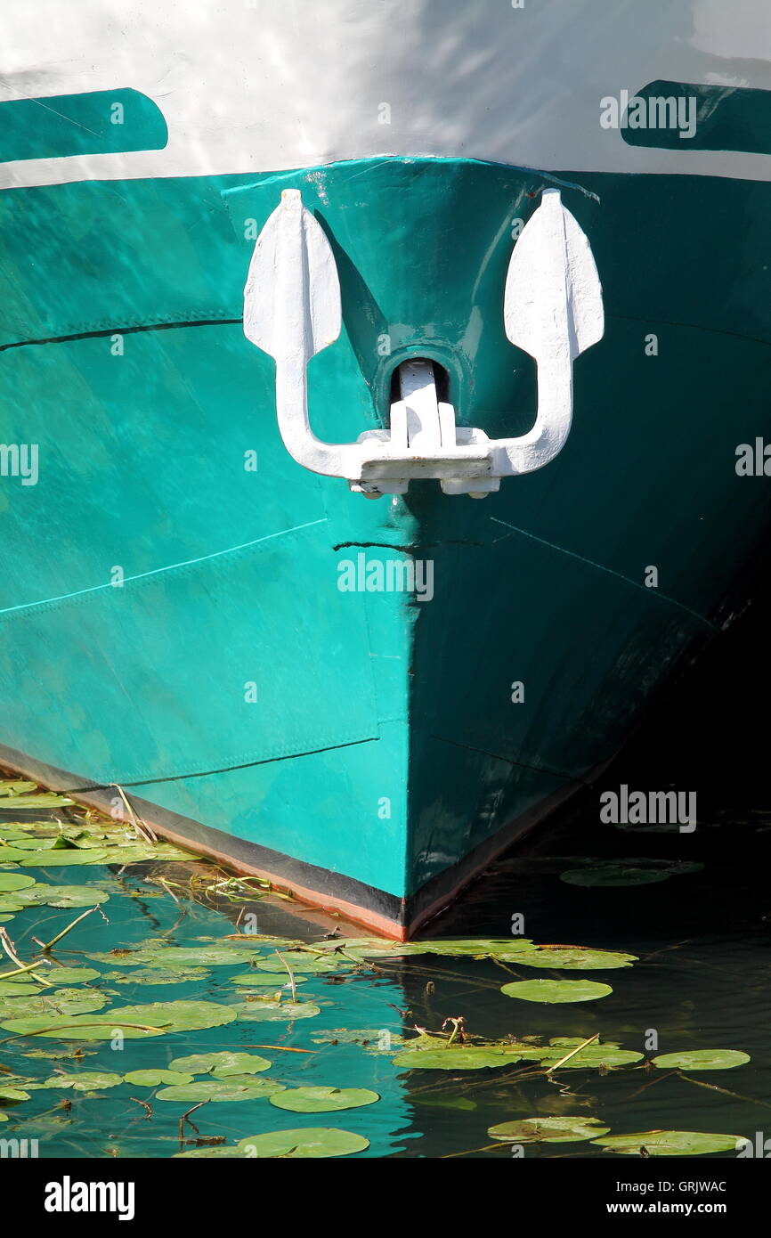 Cyan bow of the ship with white anchor Stock Photo - Alamy