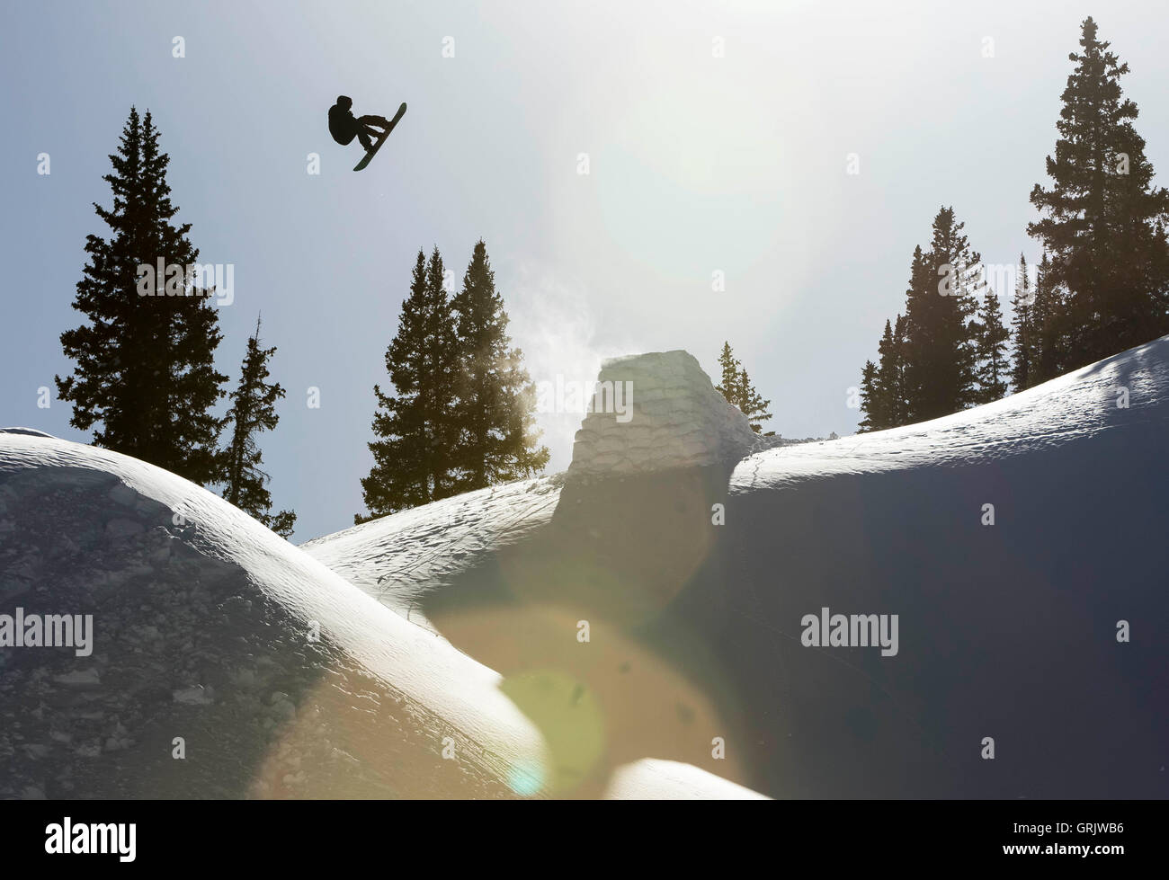 Snowboarder Hitting A Jump Stock Photo - Alamy
