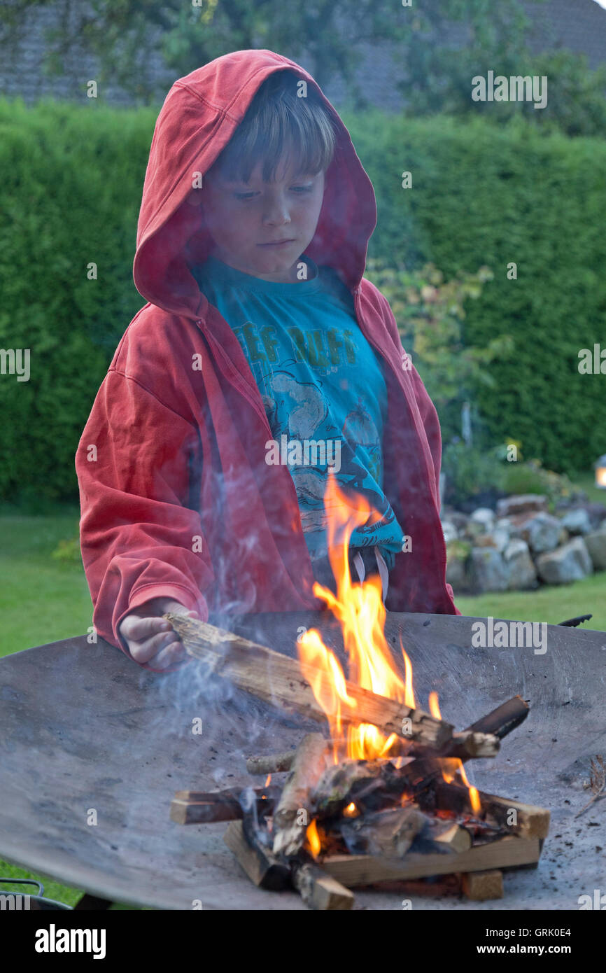 young boy playing with fire Stock Photo - Alamy