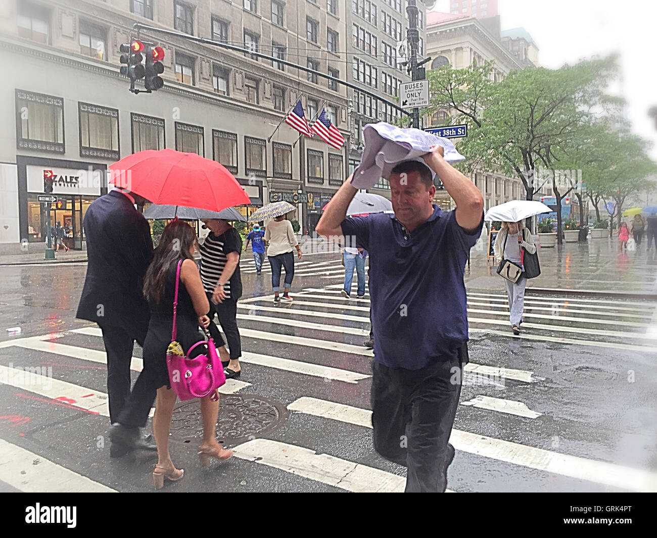 Activity under Brollies on Fifth Avenue during Rainstorm, New York City ...