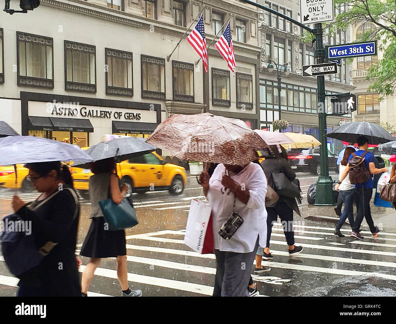 Activity under Brollies on Fifth Avenue during Rainstorm, New York City ...
