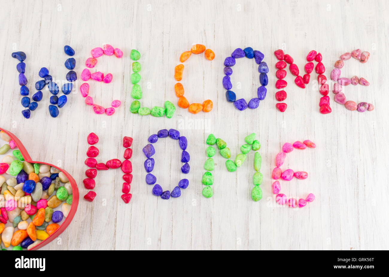 Welcome home note written with small colorful rocks Stock Photo - Alamy