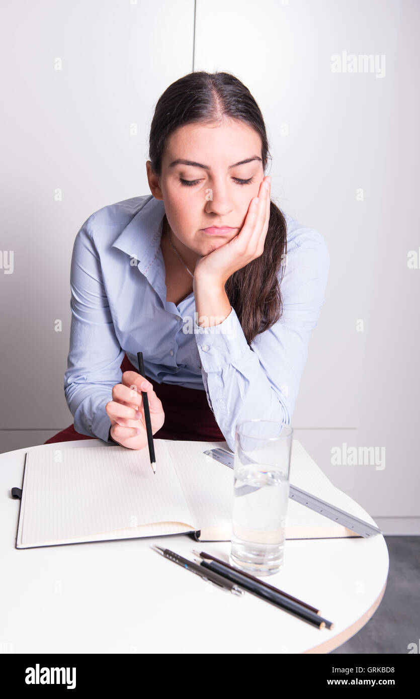 young business woman is sitting bored in the office Stock Photo - Alamy