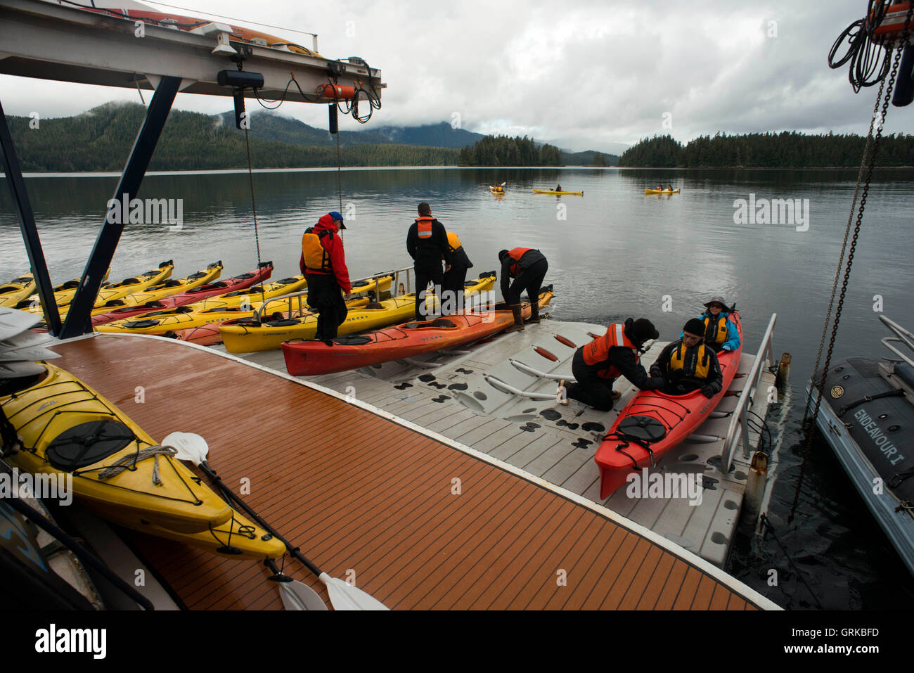 People getting into sea kayaks on loading dock cruise ship Safari ...