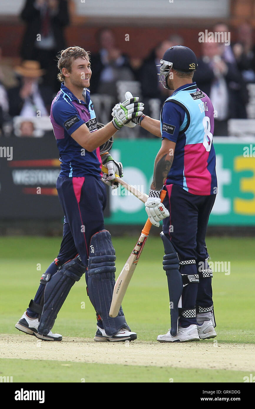 Dawid Malan (L) celebrates scoring his century with batting partner ...