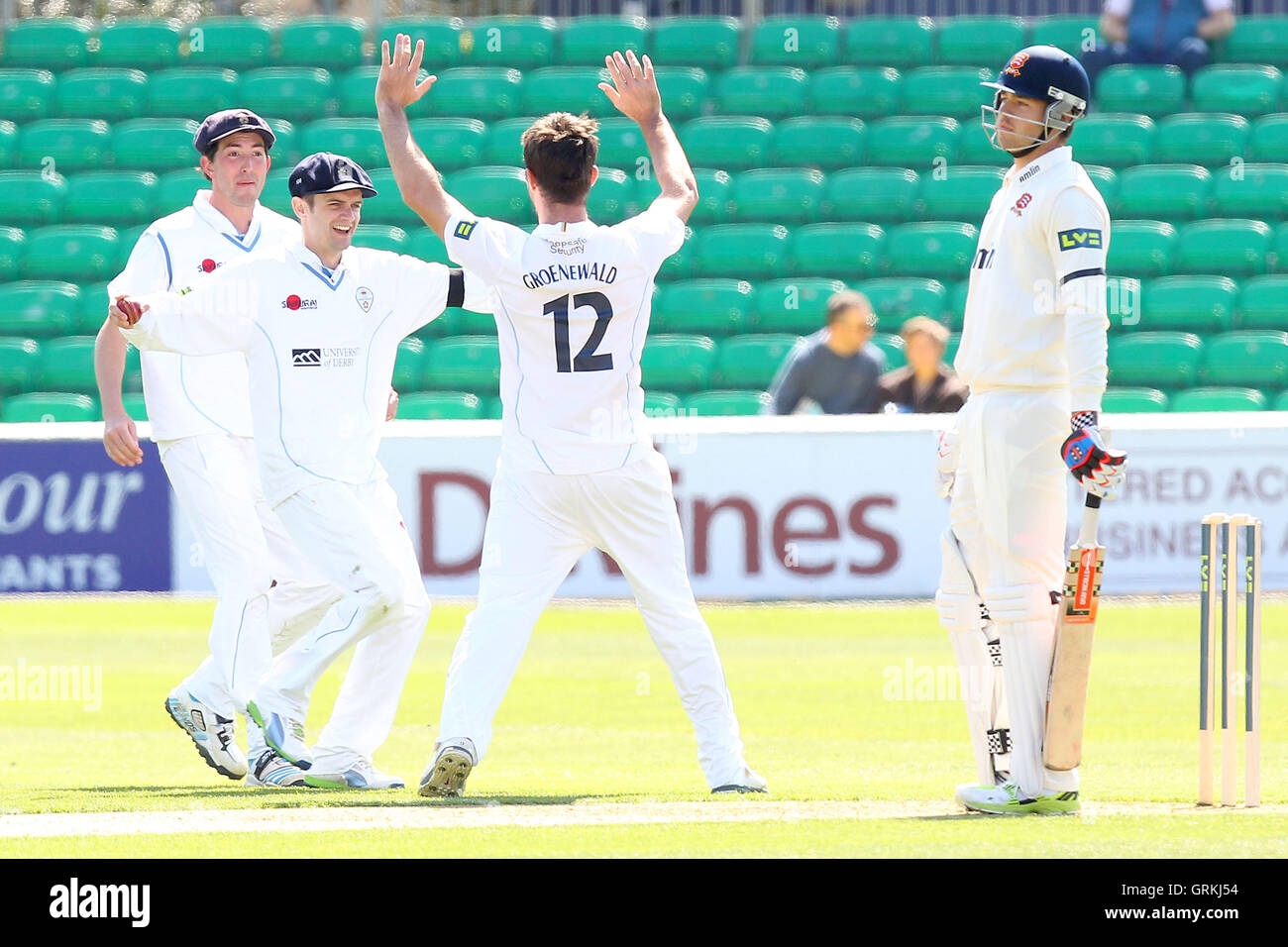 Tim Groenewald of Derbyshire claims the wicket of Ben Foakes (R) and a ...